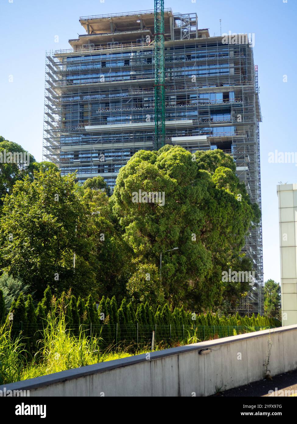 Construction of a high-rise building in a park. Exterior of a modern ...
