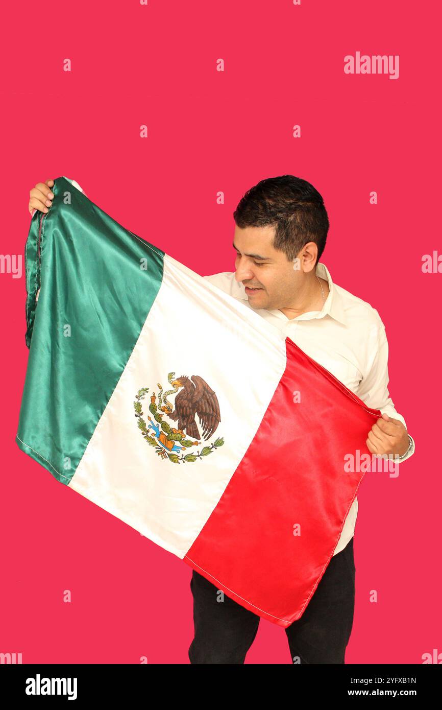 40-year-old dark-skinned mexican man proudly shows the flag of Mexico ...