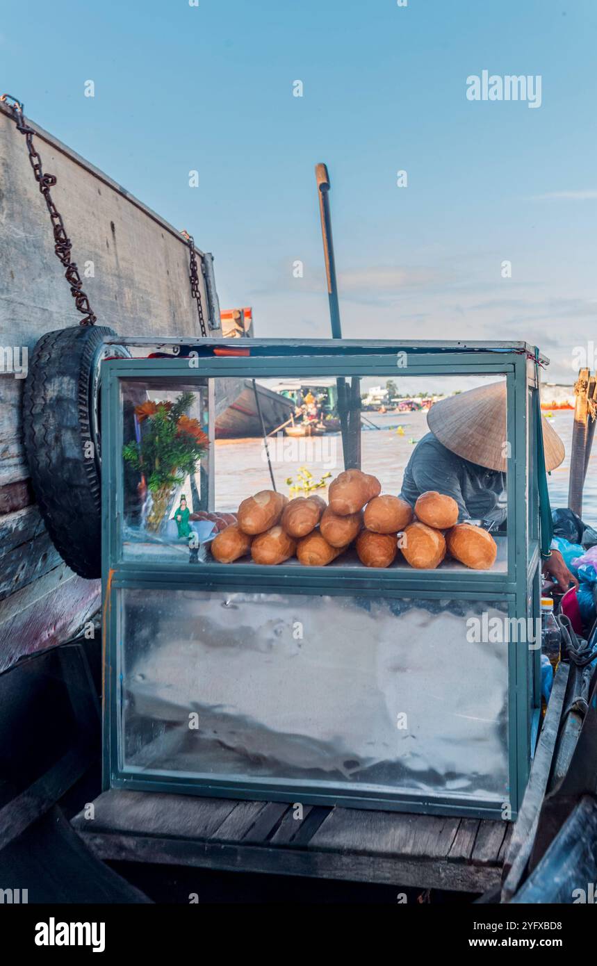 A "Bahn Mi" (Vietnamese sandwich) vendor on a rowing boat at the ...