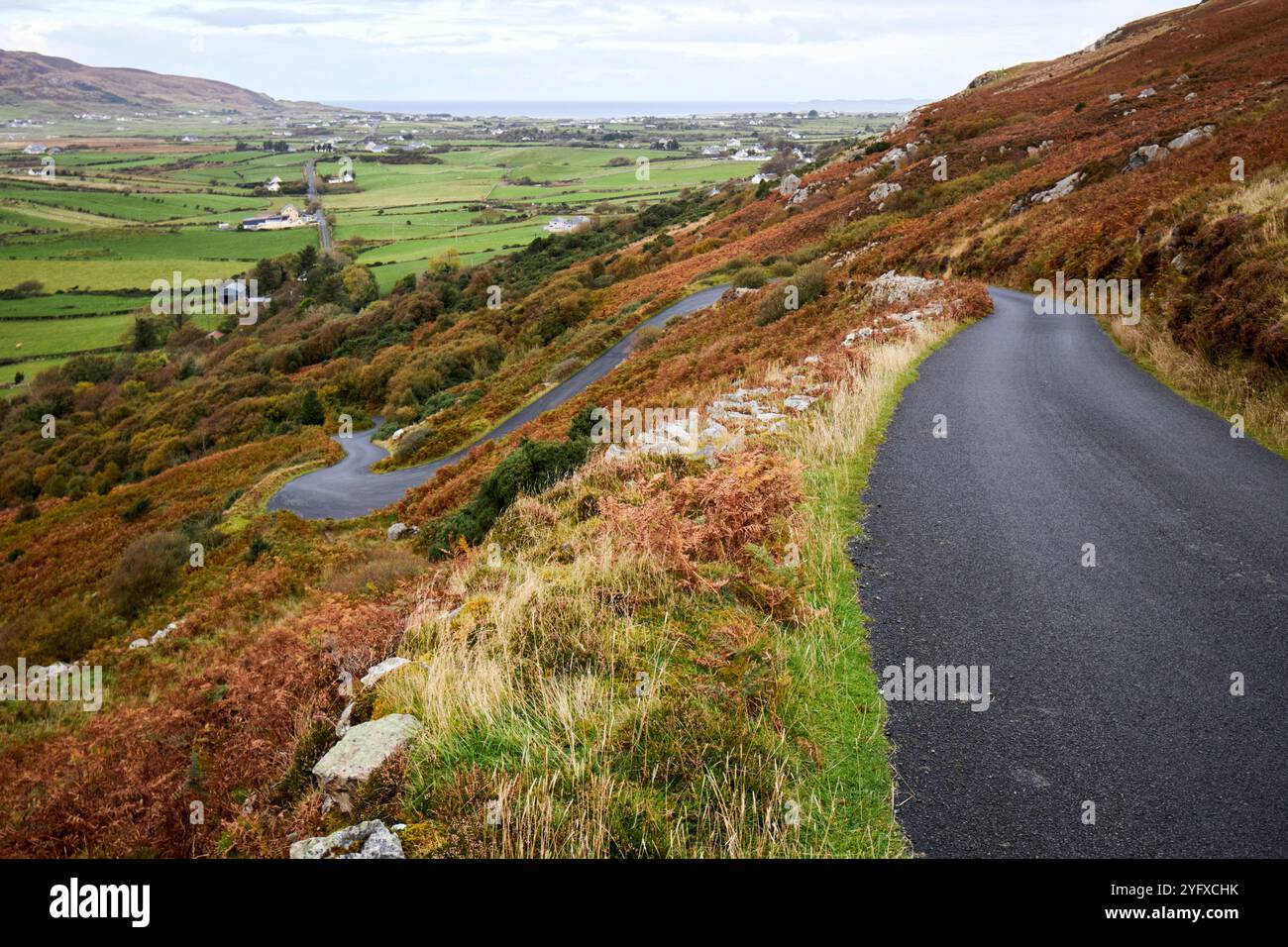 looking down from wild atlantic way discovery point to road leading up ...