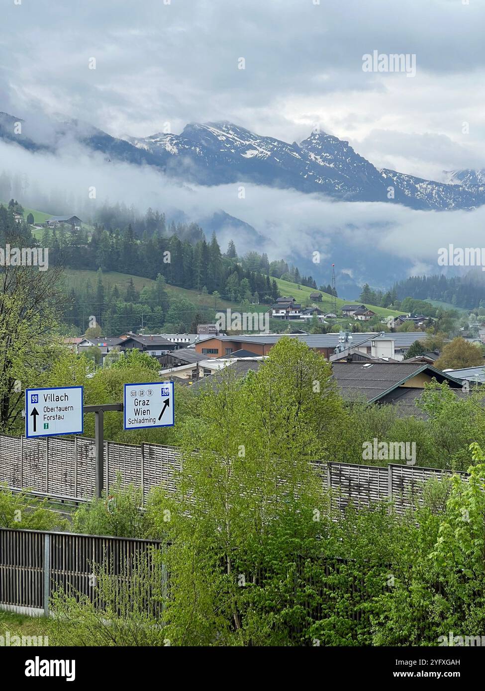 A picturesque landscape featuring alpine mountains, lush greenery, and ...