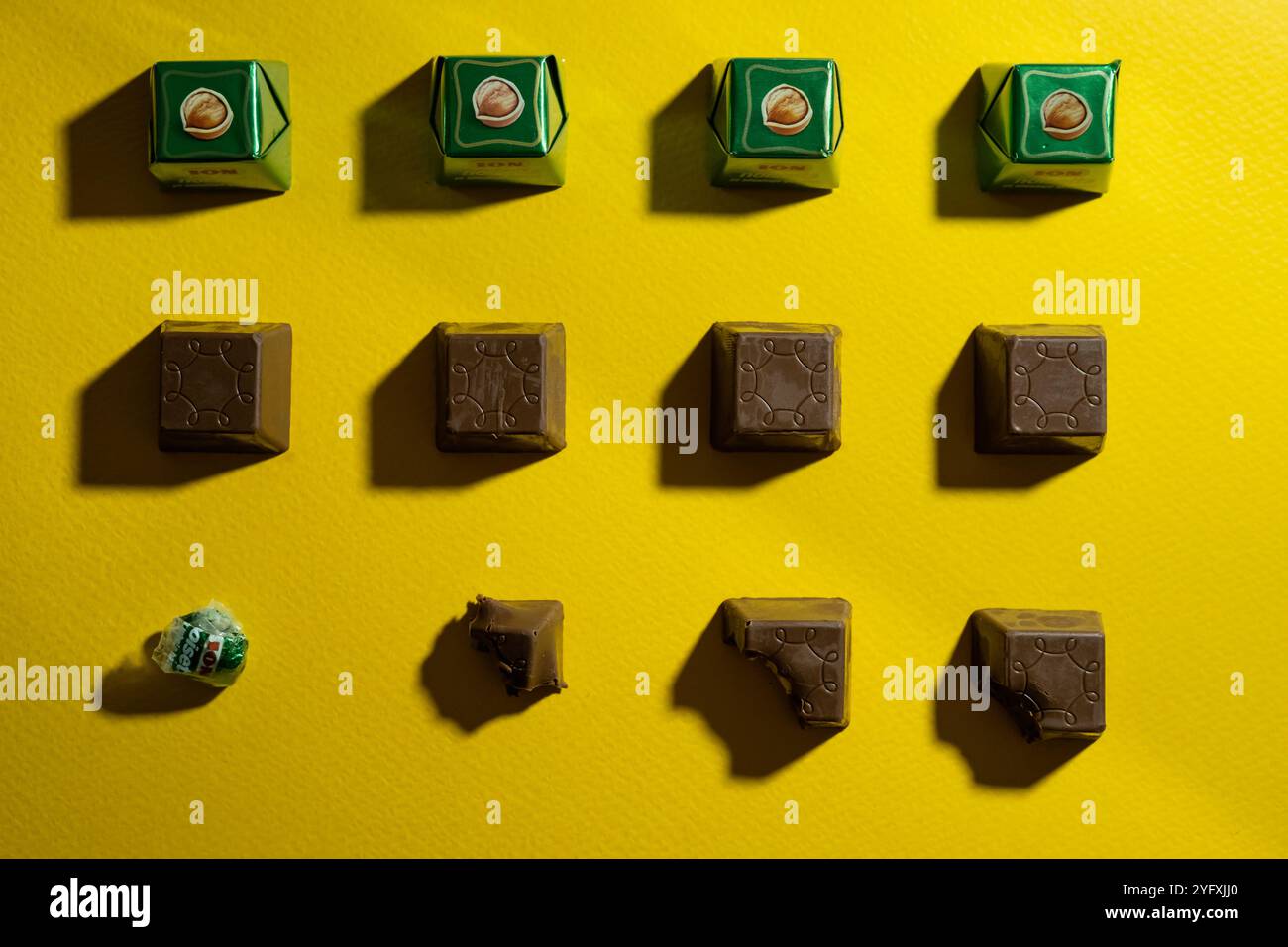 Chocolate candy in a pattern, on a yellow background, telling a story ...
