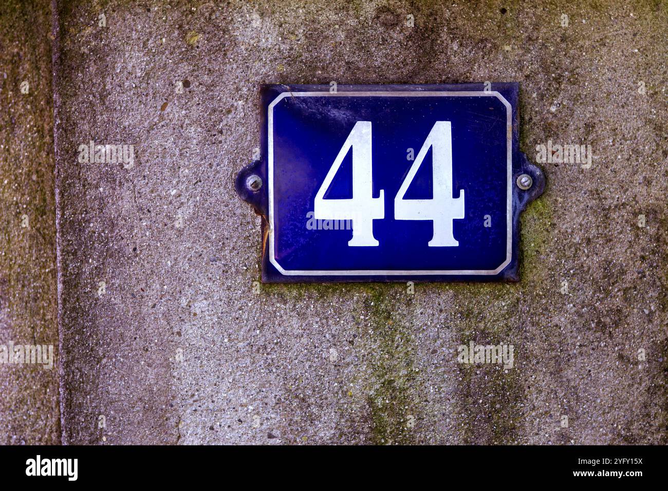 Metal panel with the number 44 on a wall Stock Photo - Alamy