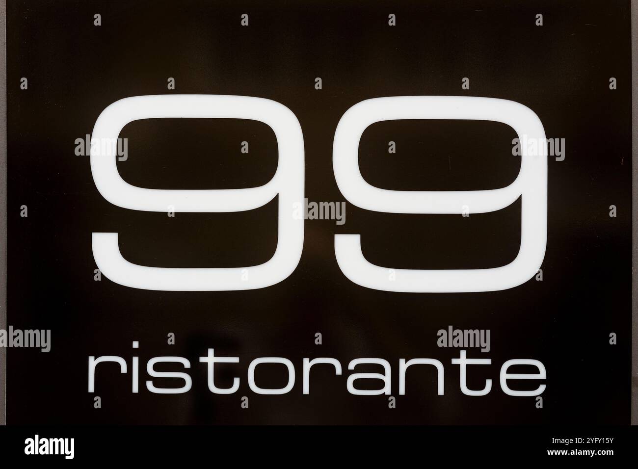 Metal black panel with the number 99 Stock Photo - Alamy