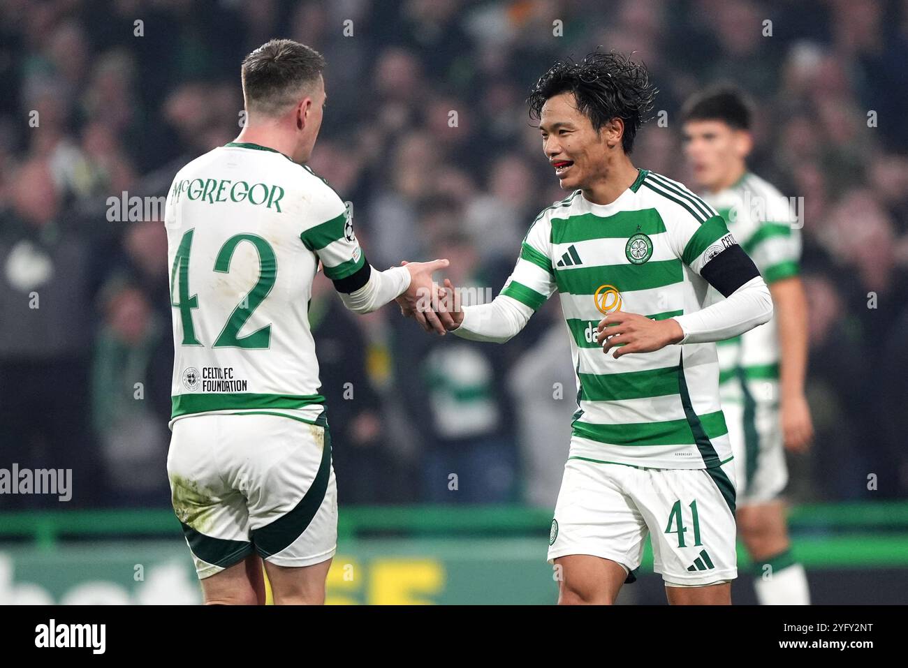 Celtic's Reo Hatate (right) celebrates scoring their side's third goal ...