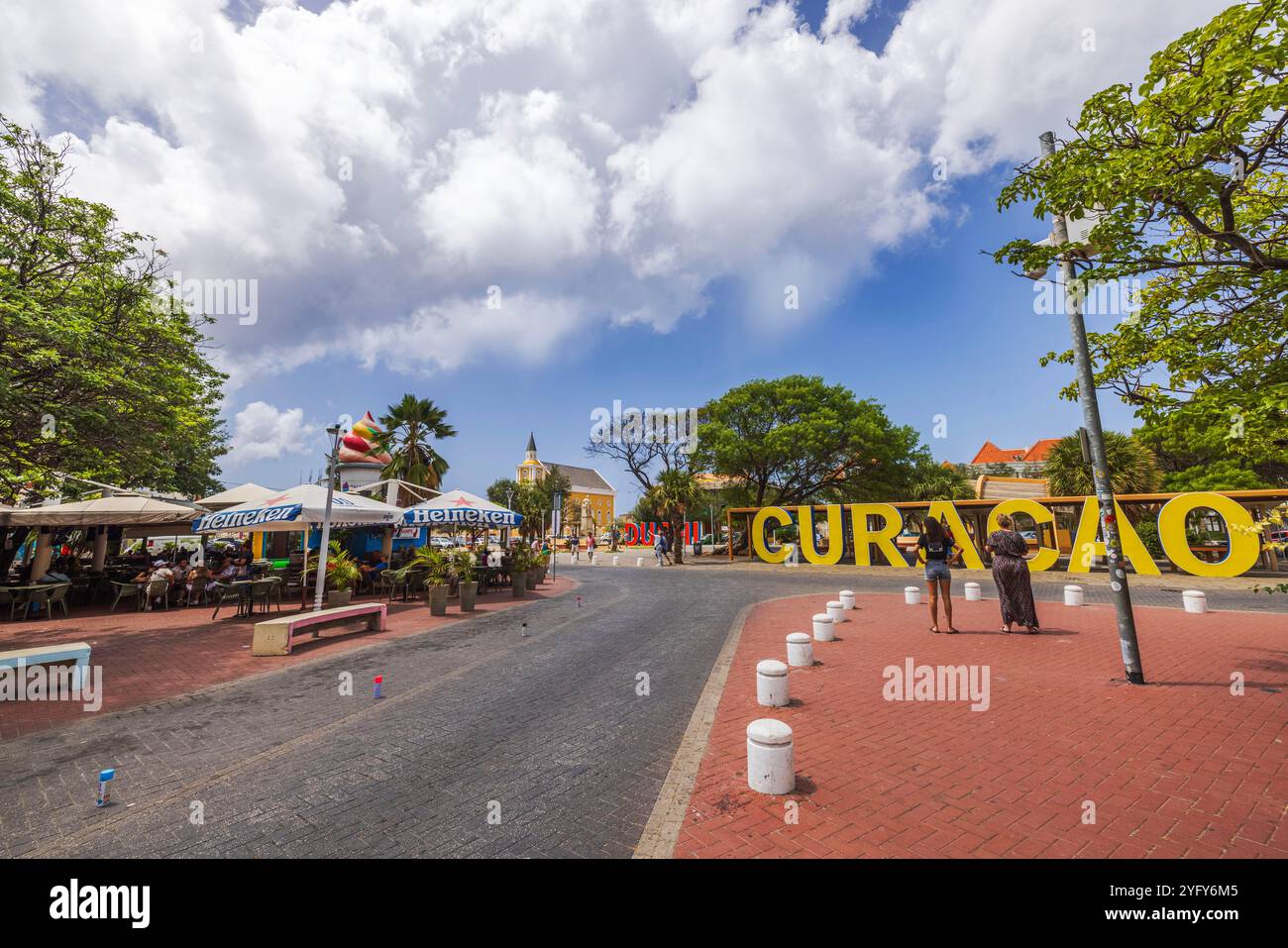 Cafe with Heineken sign near large yellow Curacao letters on an open ...