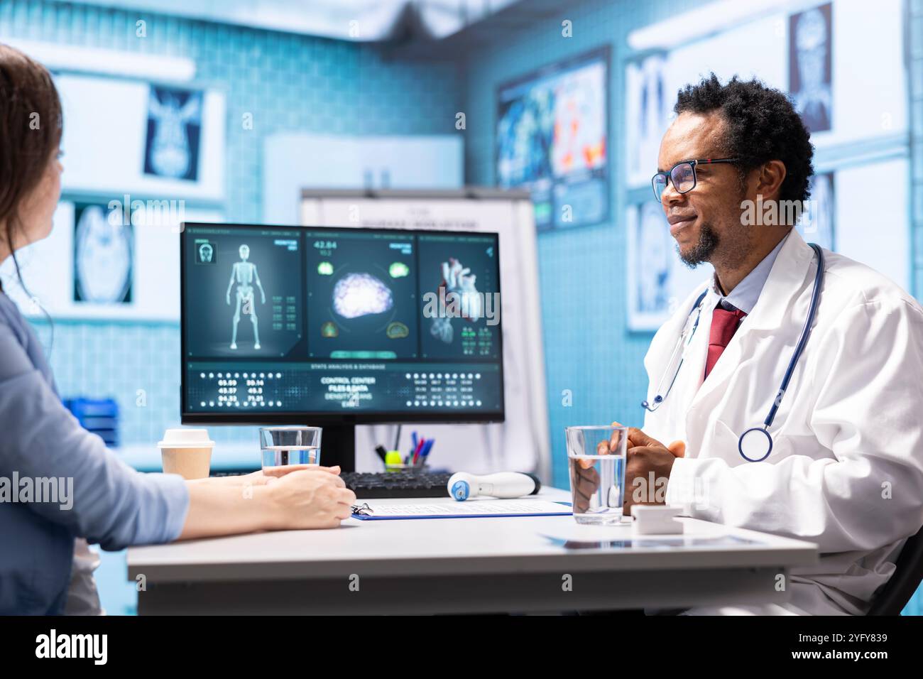 Physician reviewing MRI scan and x ray test results with a patient in ...