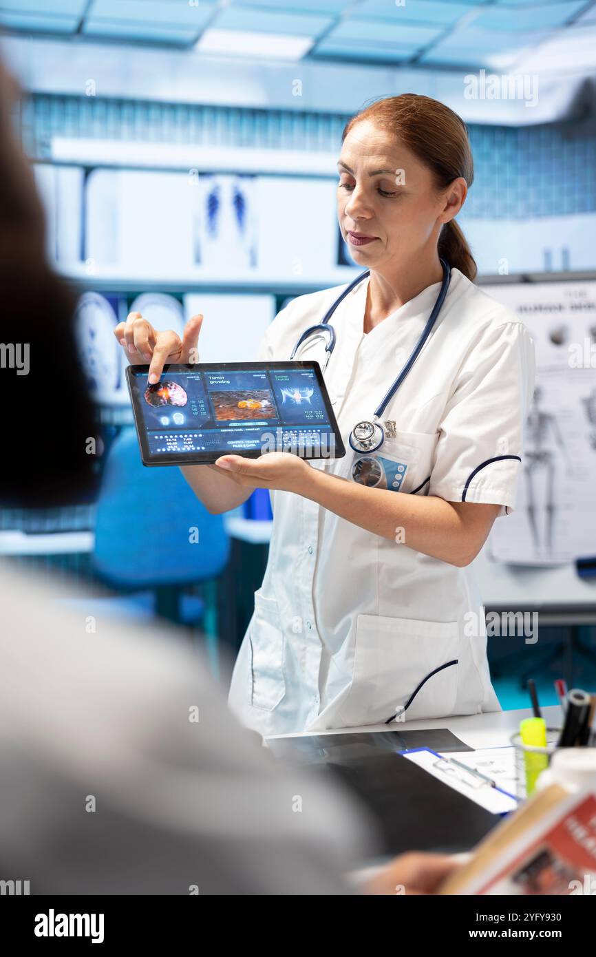 Professional neuroscientist shows mri scan test results to her staff to ...