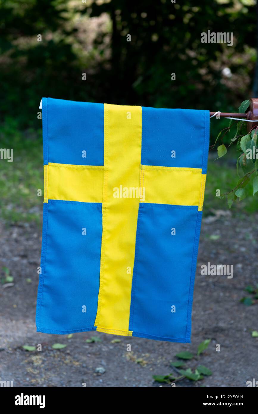 Traditional midsummer pole with small Swedish flag Stock Photo - Alamy