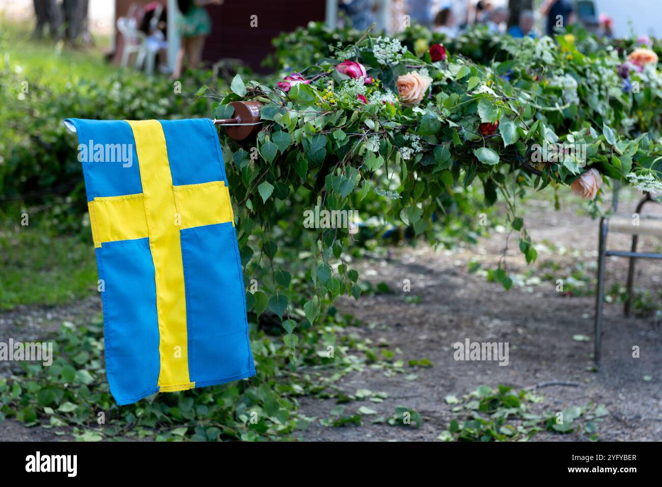 Traditional midsummer pole with small Swedish flag Stock Photo - Alamy
