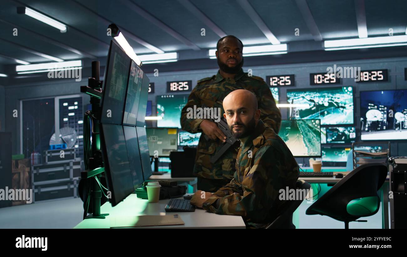 Soldier doing tasks in military base, doing surveillance with digital radar equipment, operating ...