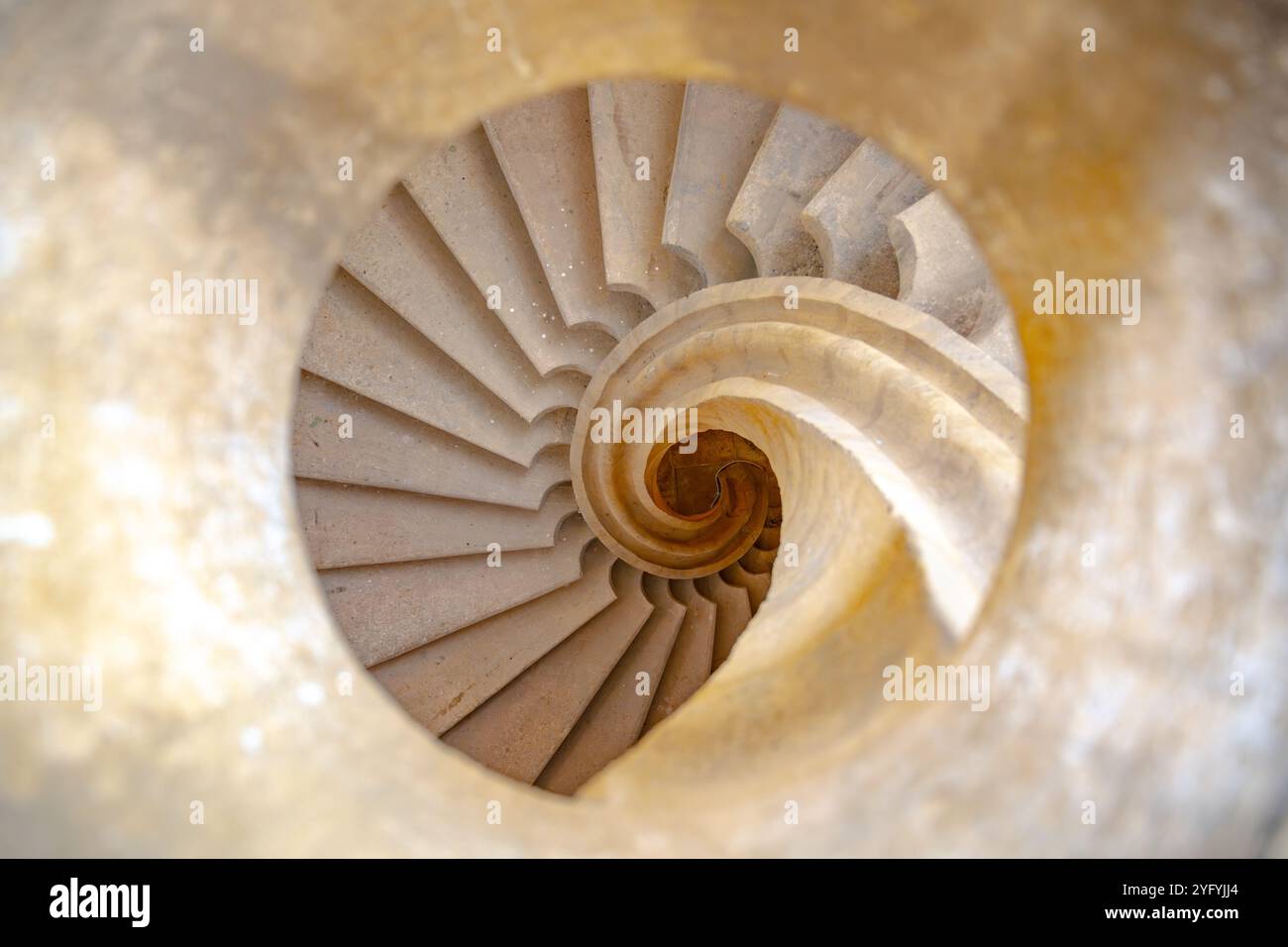 The helical staircase features smooth, curved steps that ascend ...