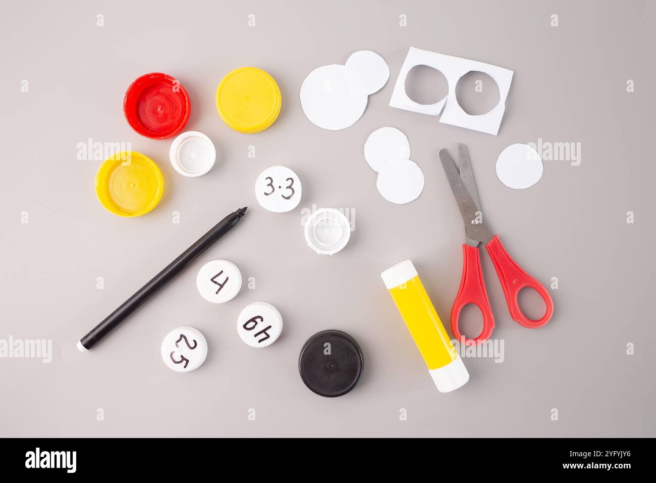 Step-by-step tutorial with scissors, glue, and markers on grey background. Educational concept ...