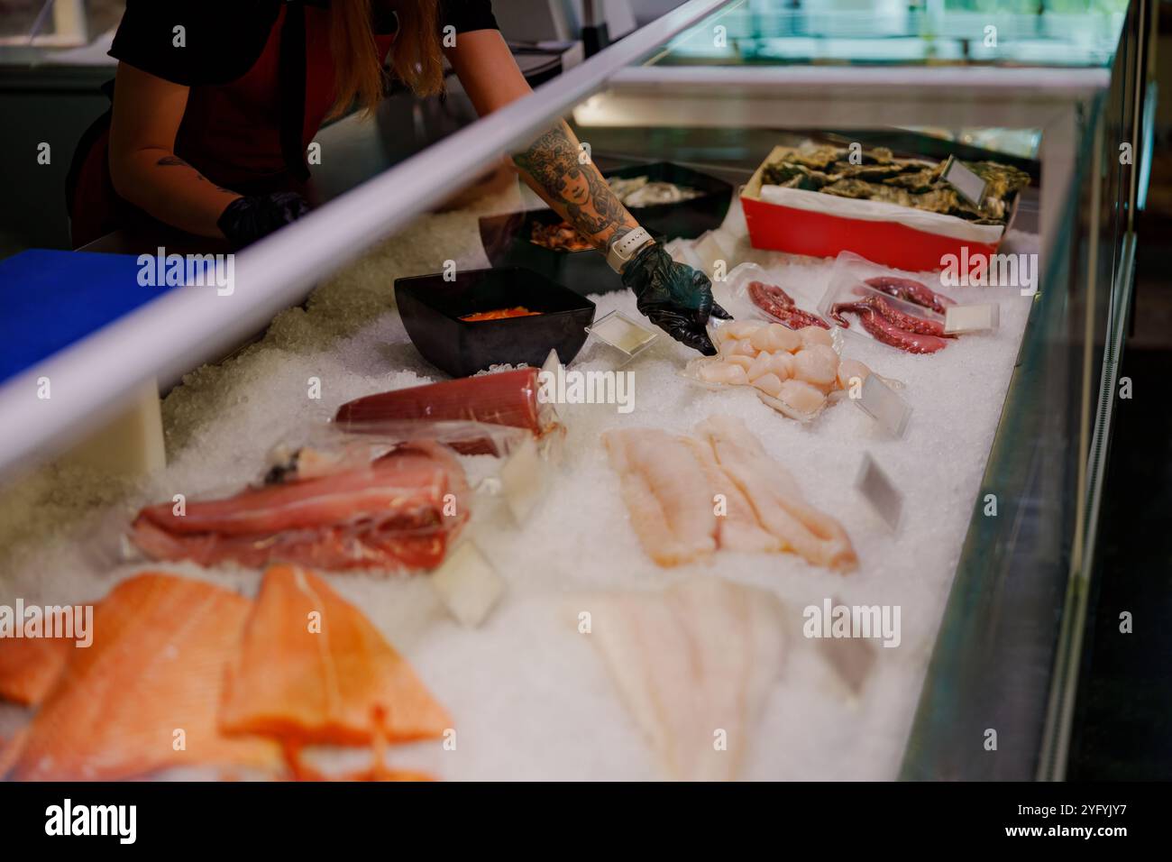 Fresh Seafood Display at a busy market featuring various fish and ...