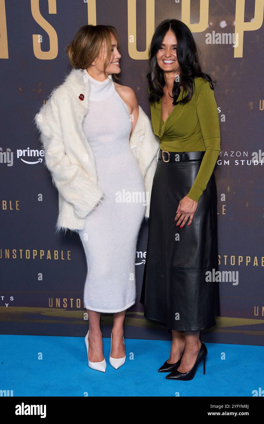 Jennifer Lopez, left, and Judy Robles pose for photographers upon ...