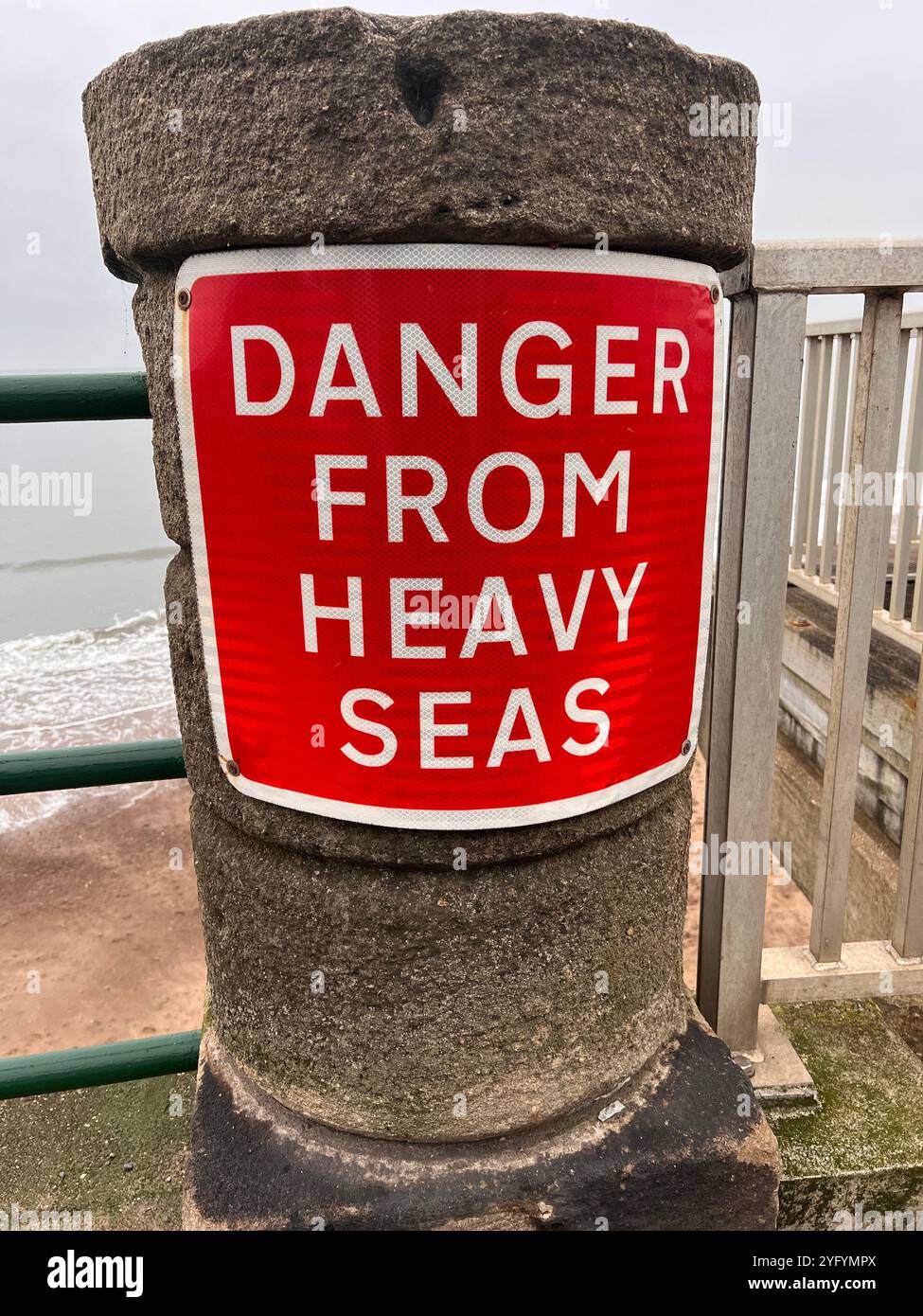 Danger from heavy seas warning sign on the sea wall at Sandsend, East ...