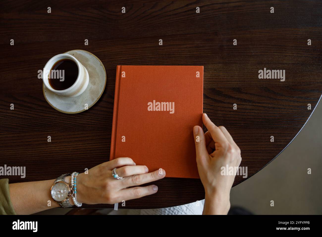 A cozy reading scene featuring a warm cup of coffee and a journal ...
