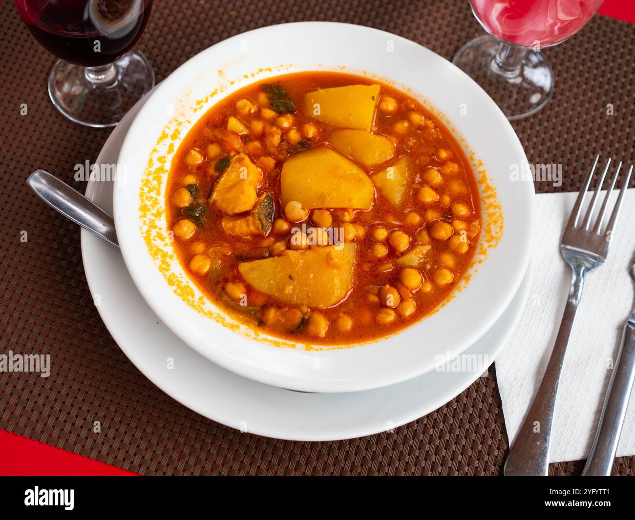 Chickpea stew served with cod fish Stock Photo - Alamy