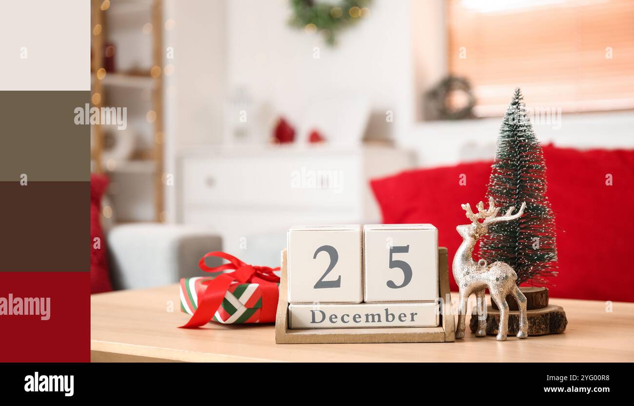 Cube calendar with date of Christmas, decor and gift on table in room ...