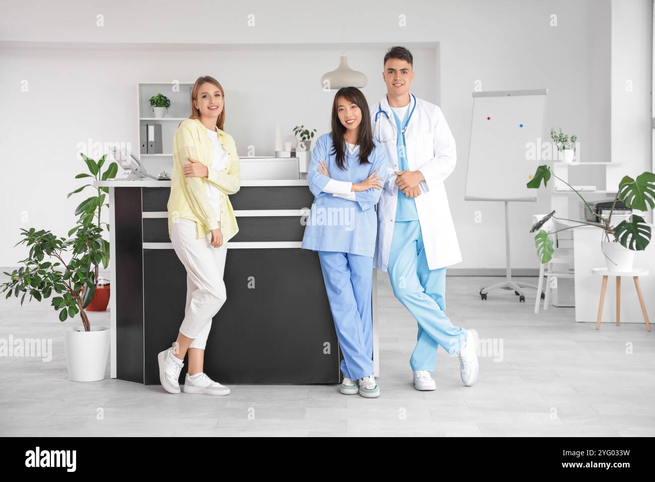 Medical intern with doctor and patient at reception in clinic Stock ...