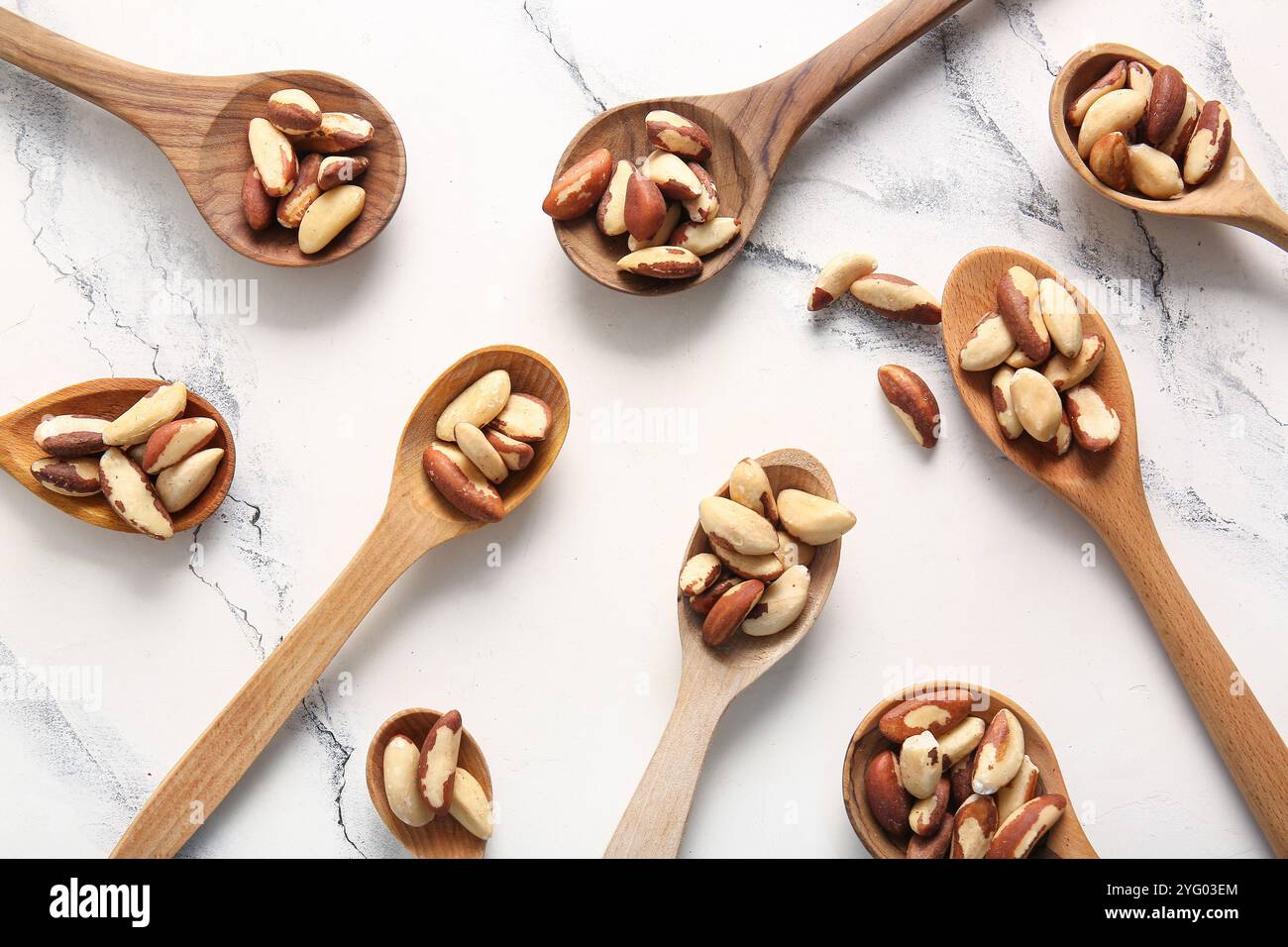 Wooden spoons with tasty Brazil nuts on white background Stock Photo ...