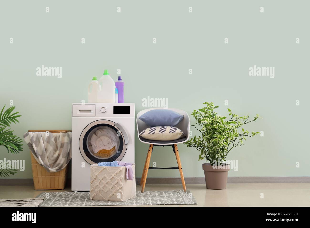 Interior of laundry room with washing machine, baskets and chair Stock ...