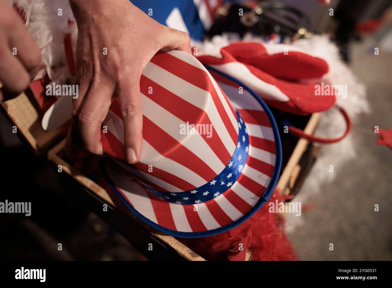 Berlin, Germany. 06th Nov, 2024. A guest grabs a top hat with the US ...