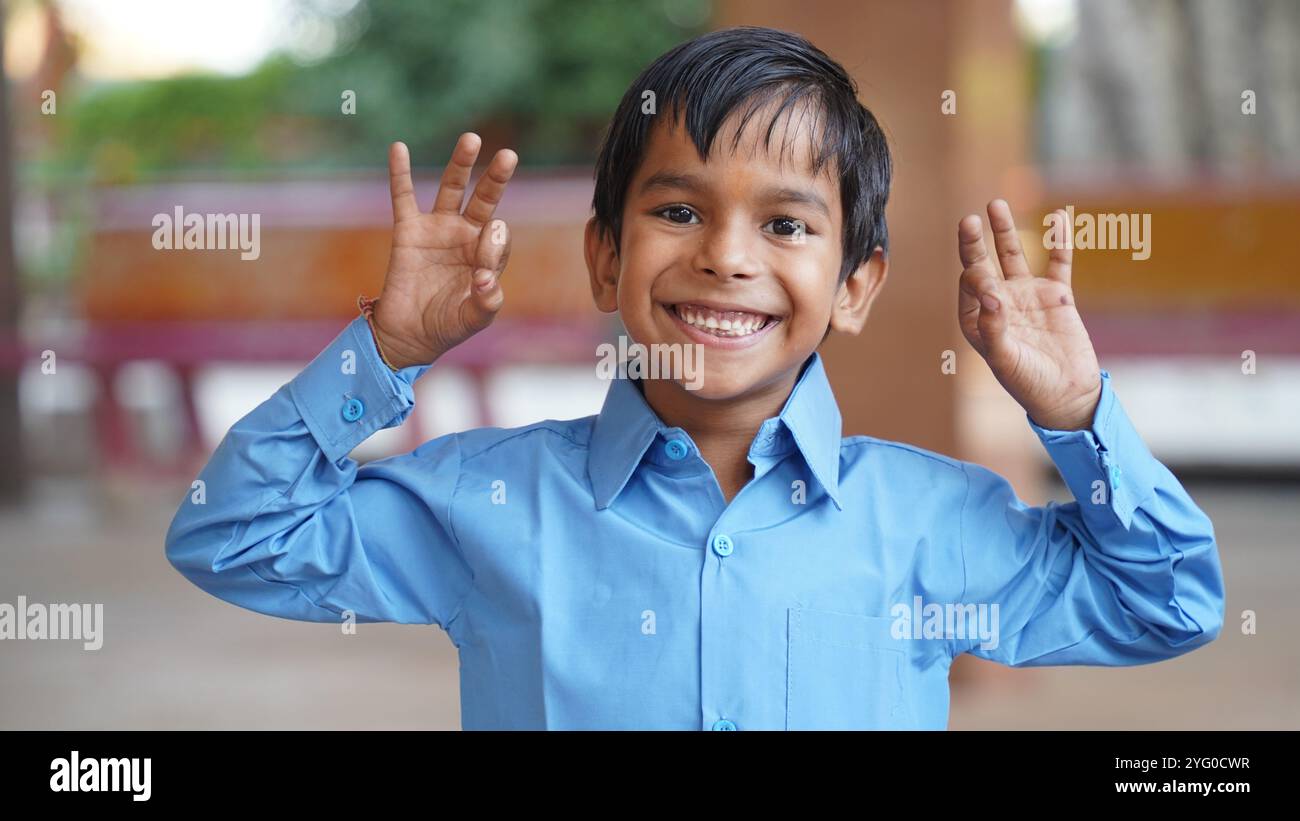 Portrait of Happy cheerful Indian school child or kids in uniform ...