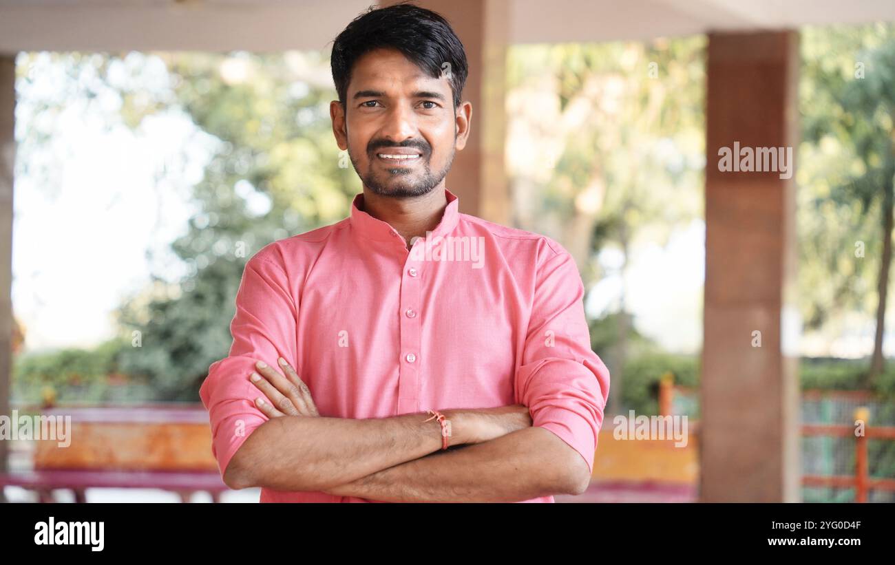 Confident young indian man wearing ethical dress standing cross arms ...