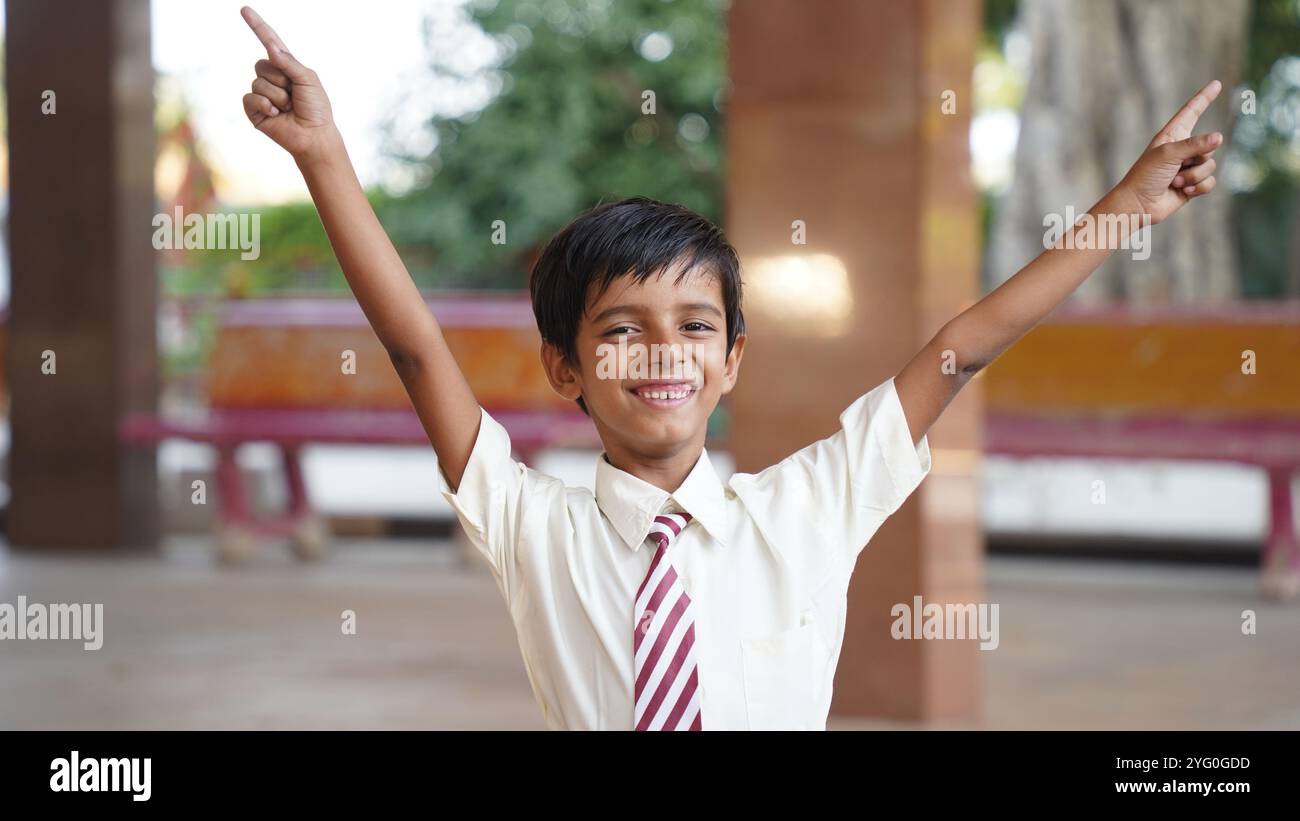 Portrait of Happy cheerful Indian school child or kids in uniform ...