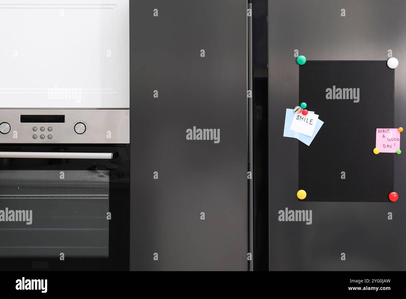 Magnetic board and notes on refrigerator in kitchen Stock Photo - Alamy