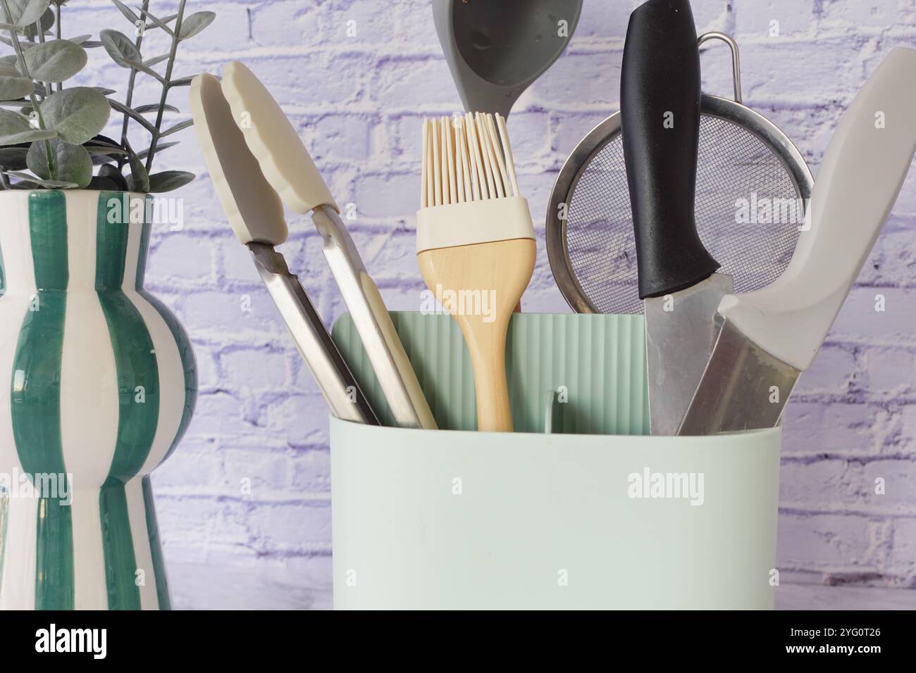 A collection of stylish kitchen utensils beautifully arranged in a ...