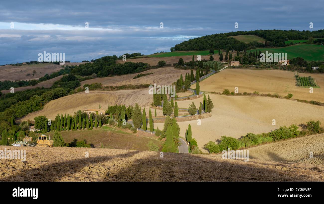 A stunning view of the Tuscan countryside reveals golden fields and ...