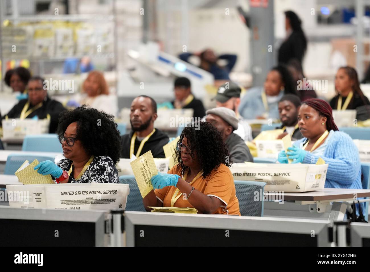 Election workers process mail-in ballots for the 2024 General Election ...