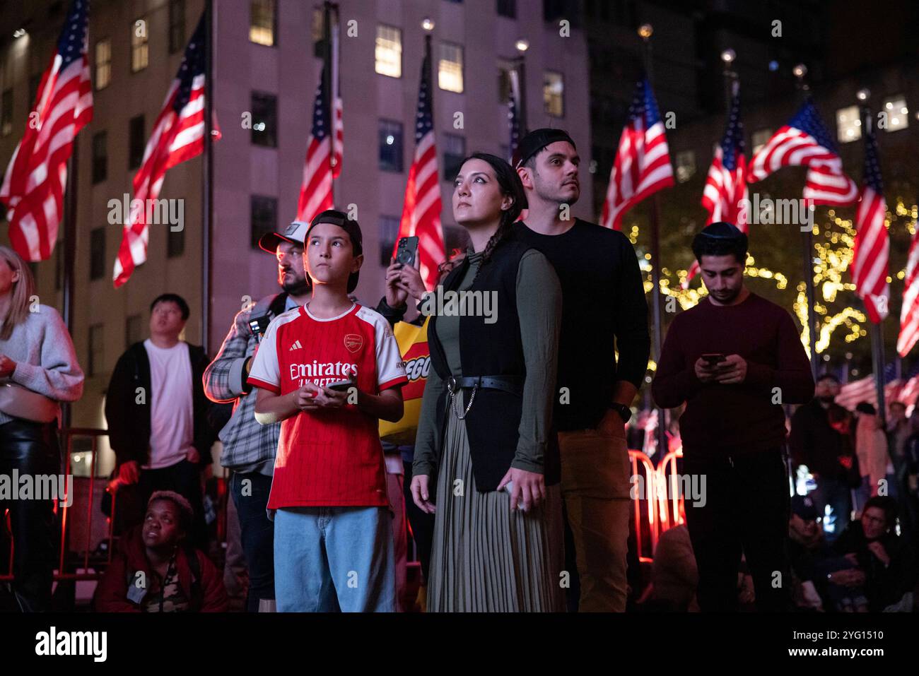 People watch an NBC News livestream showing poll results at Rockefeller ...