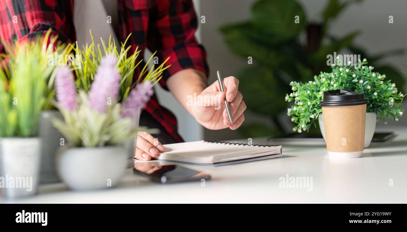 Digital Gardener Planning Plant Care with Notebook and Tech Devices ...