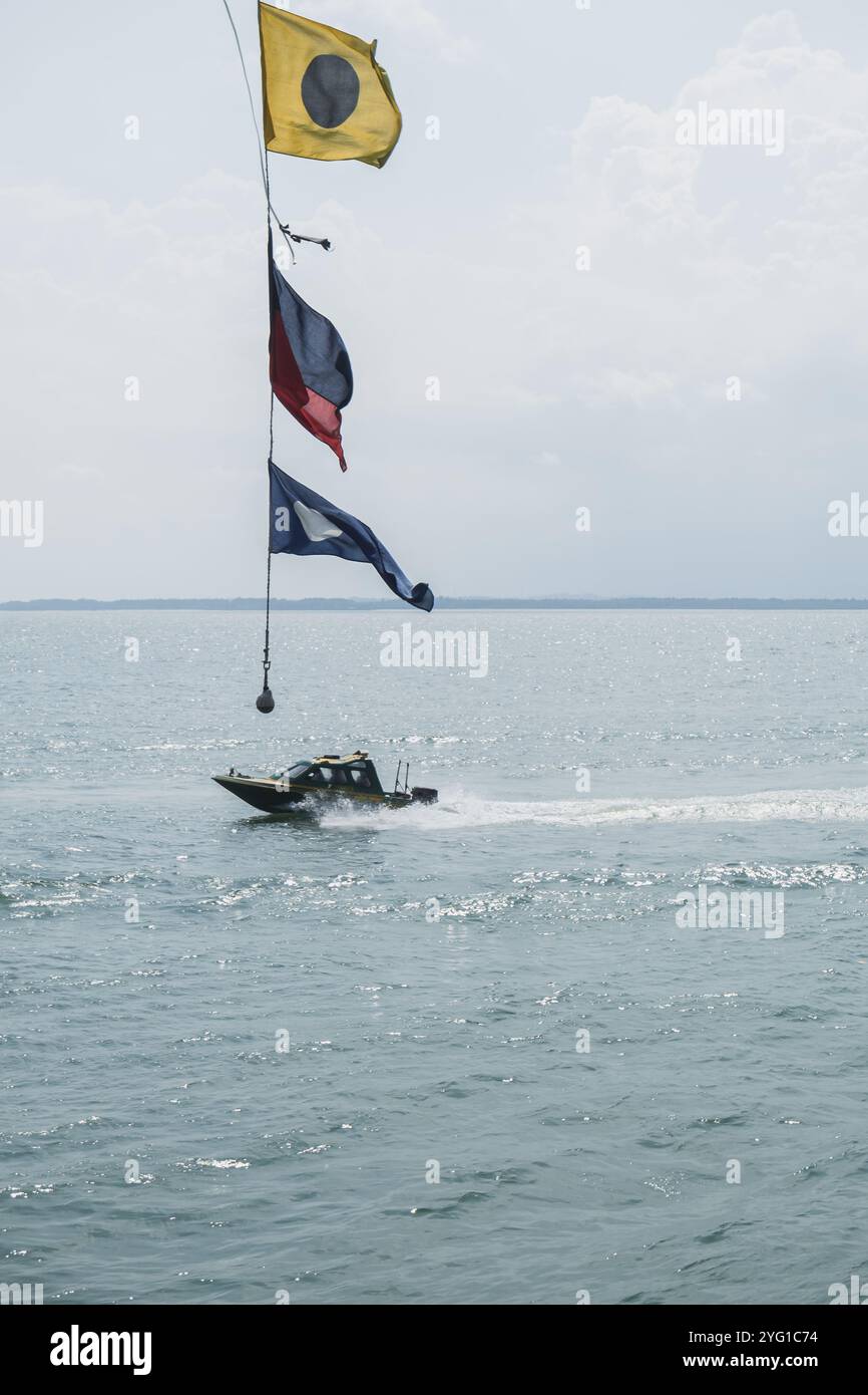A speedboat is seen moving directly under the pendulum for the flag ...