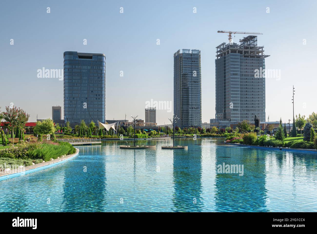 Contemporary buildings reflected in pool of Tashkent City Park Stock ...