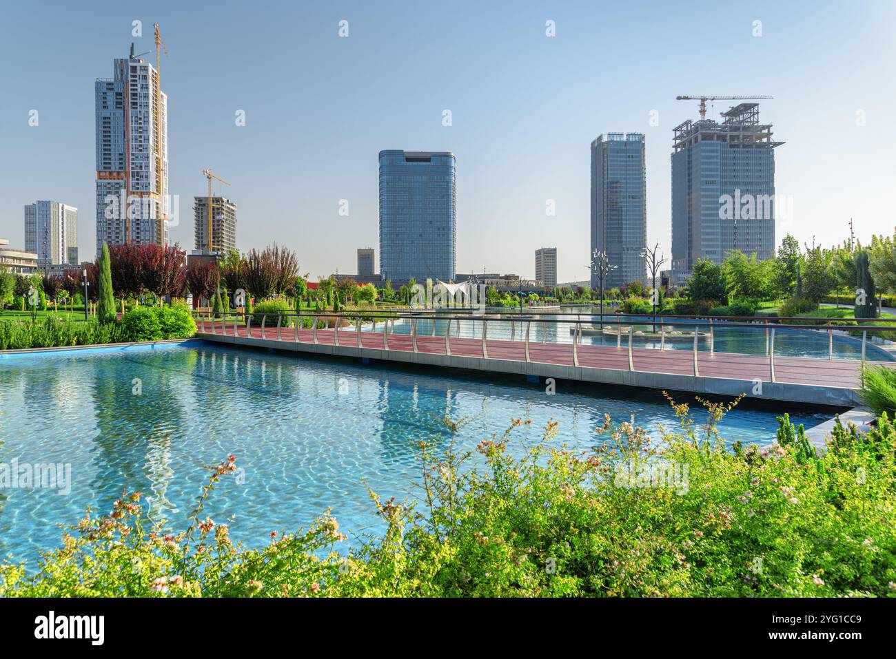 Contemporary buildings reflected in pool of Tashkent City Park Stock ...