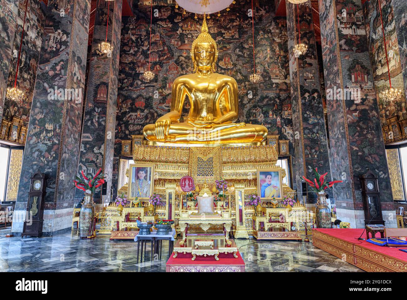 Awesome view of gilded Buddha statue among amazing murals Stock Photo ...