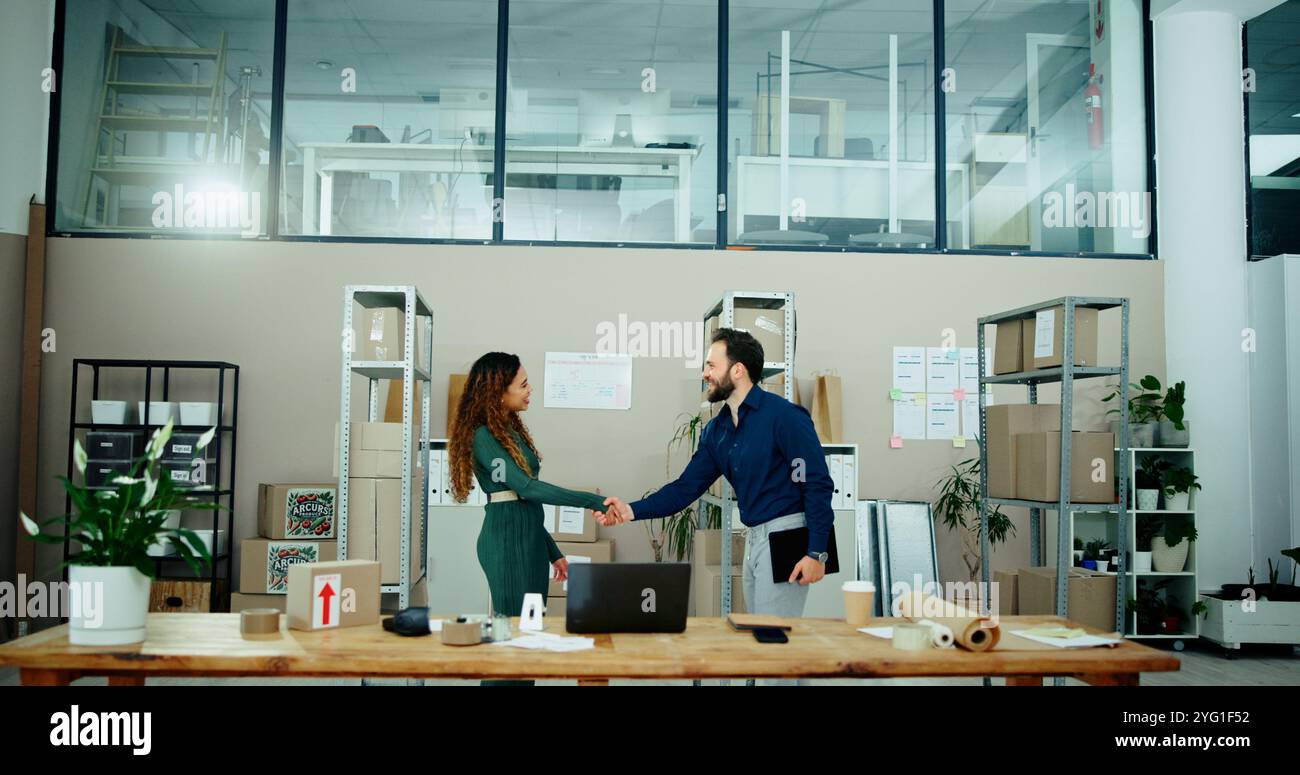Man, woman and handshake in warehouse with boxes, deal and b2b ...