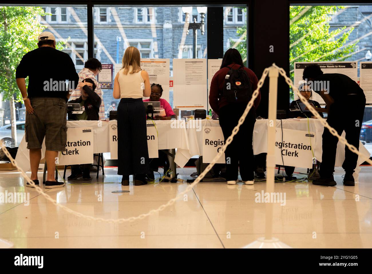 Voters stand in line at a local polling station in Washington, DC, on ...