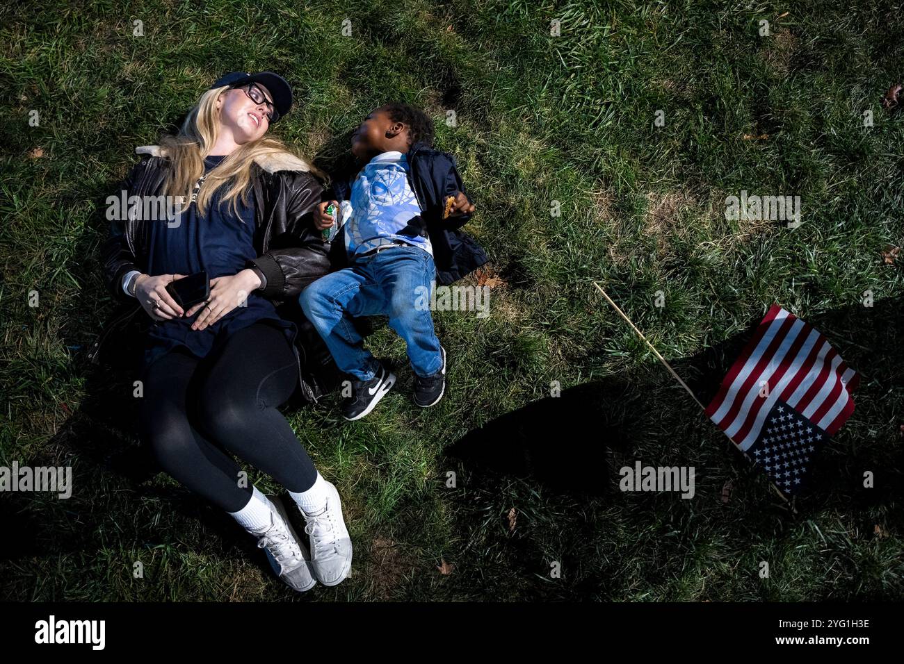 Elizabeth Cavalieri lays with Chibundu Achebe Nnake II and an American ...
