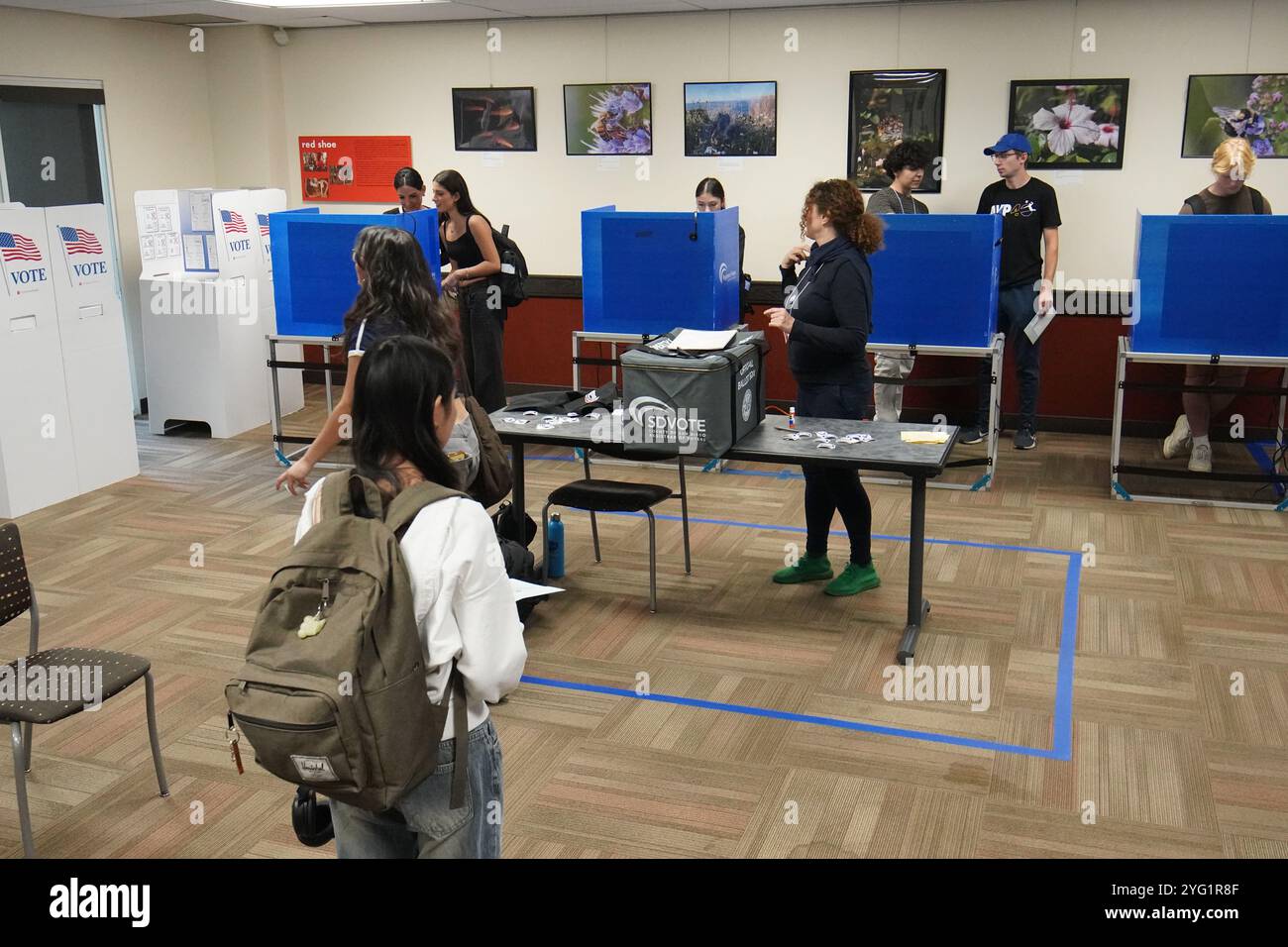 People vote inside one of the vote centers at University of California ...