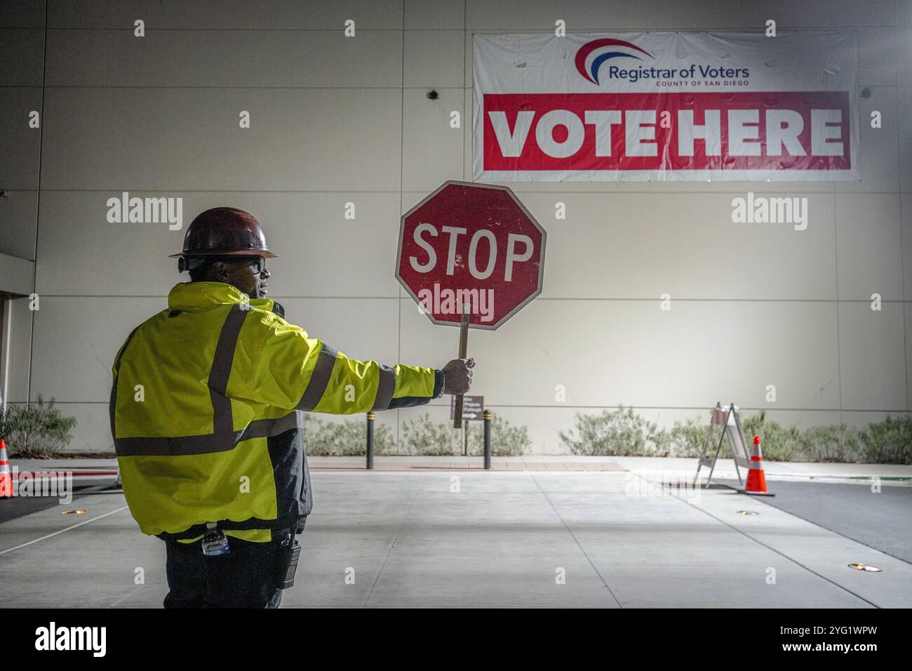 A staff of vote center holds a stop sign in front of the vote center in ...