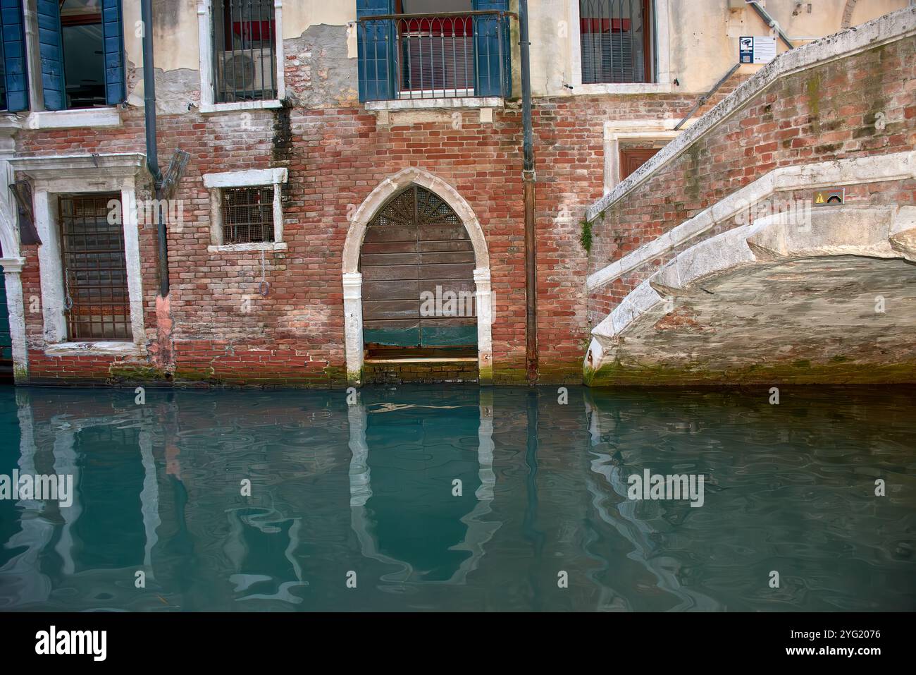 A hidden corner in Venice, Italy. This photograph captures a tranquil ...