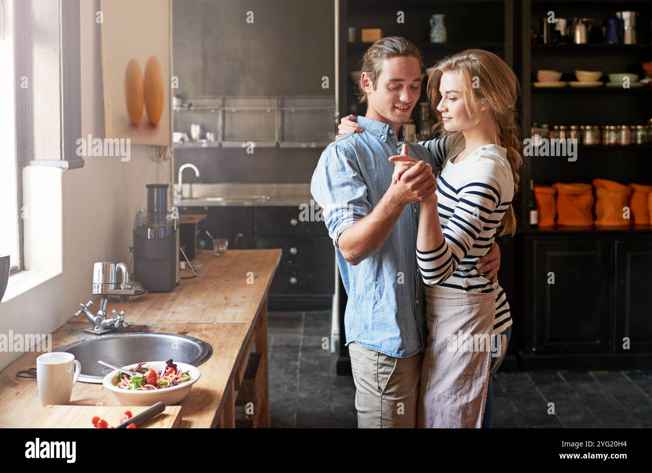 Holding hands, dancing or couple with romance cooking in kitchen for ...