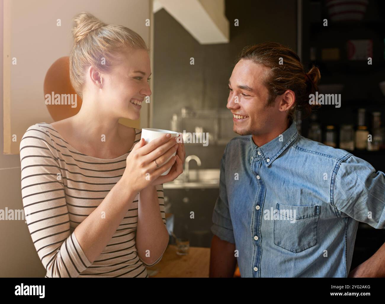 Couple, coffee and happy with bonding in kitchen for connection ...