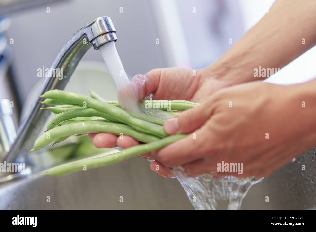 Woman washing green in kitchen hi-res stock photography and images - Alamy
