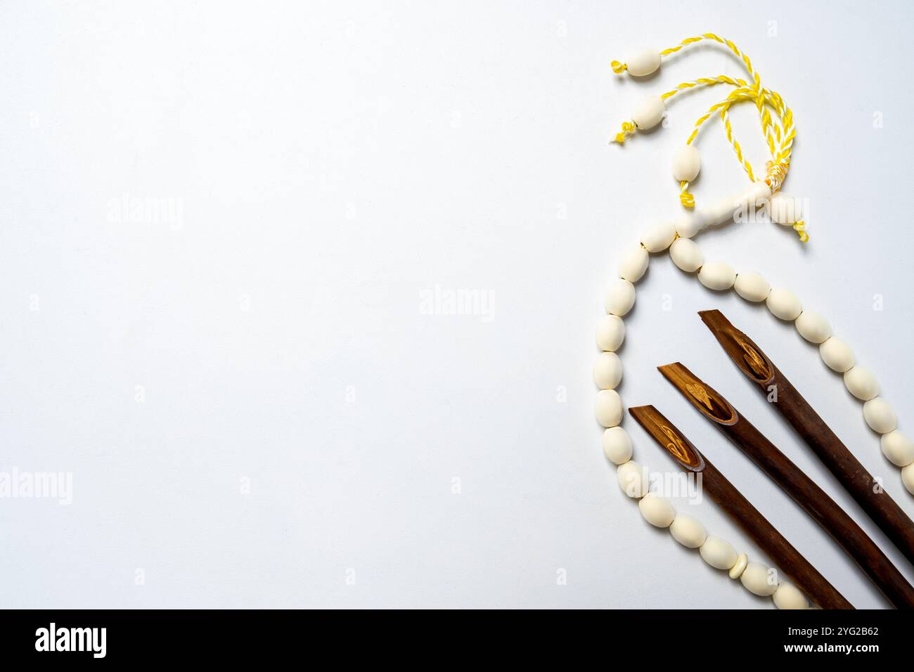 Set of calligraphy reeds and prayer beads isolated over white ...